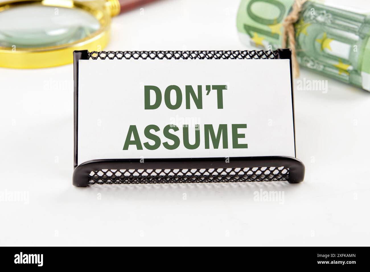 Do not Assume on a business card in a composition with Euro banknotes ...