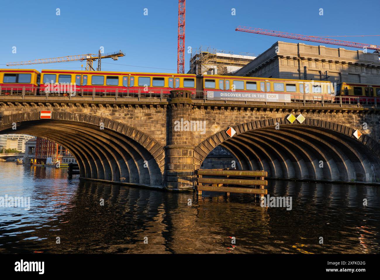 The S-bahn bridge with passing train between Hackescher Markt and ...
