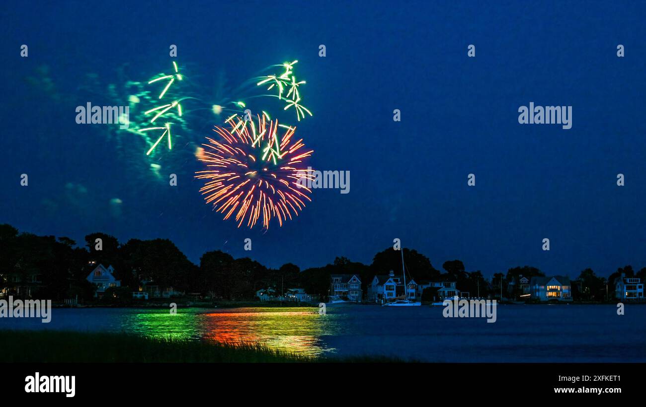 NORWALK, CT, USA - JULY 3, 2024: A red and green firework explodes over ...