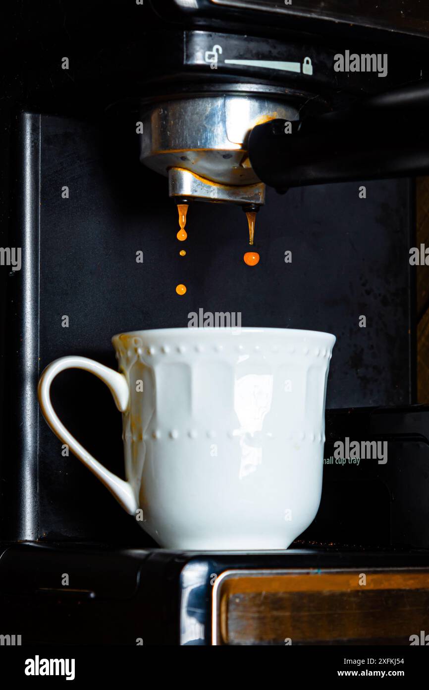 Espresso shot pouring out of an espresso maker Stock Photo - Alamy