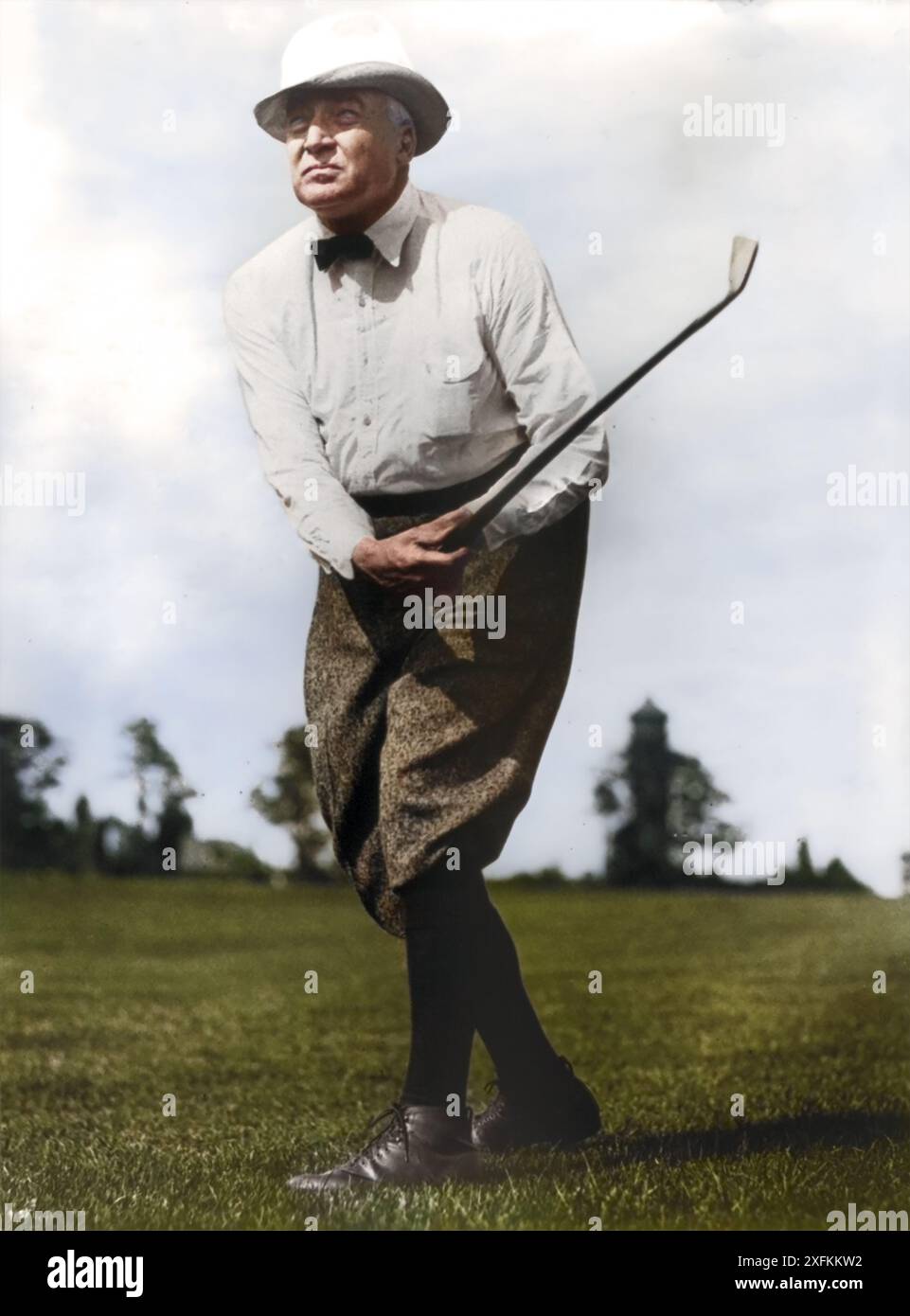 Warren G. Harding, full length, facing left, swinging golf club ...
