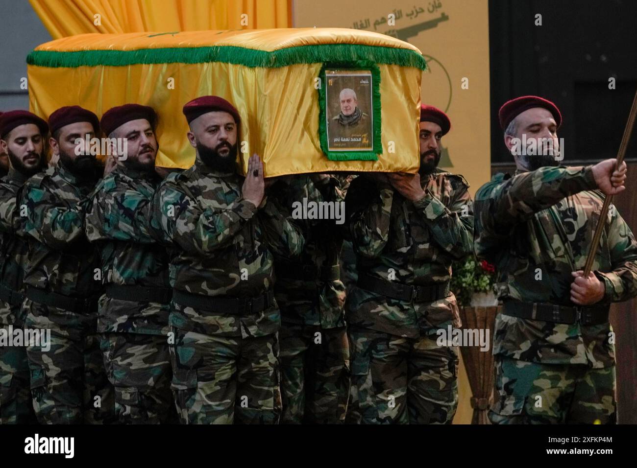 Hezbollah fighters carry the coffin of their comrade, senior commander ...