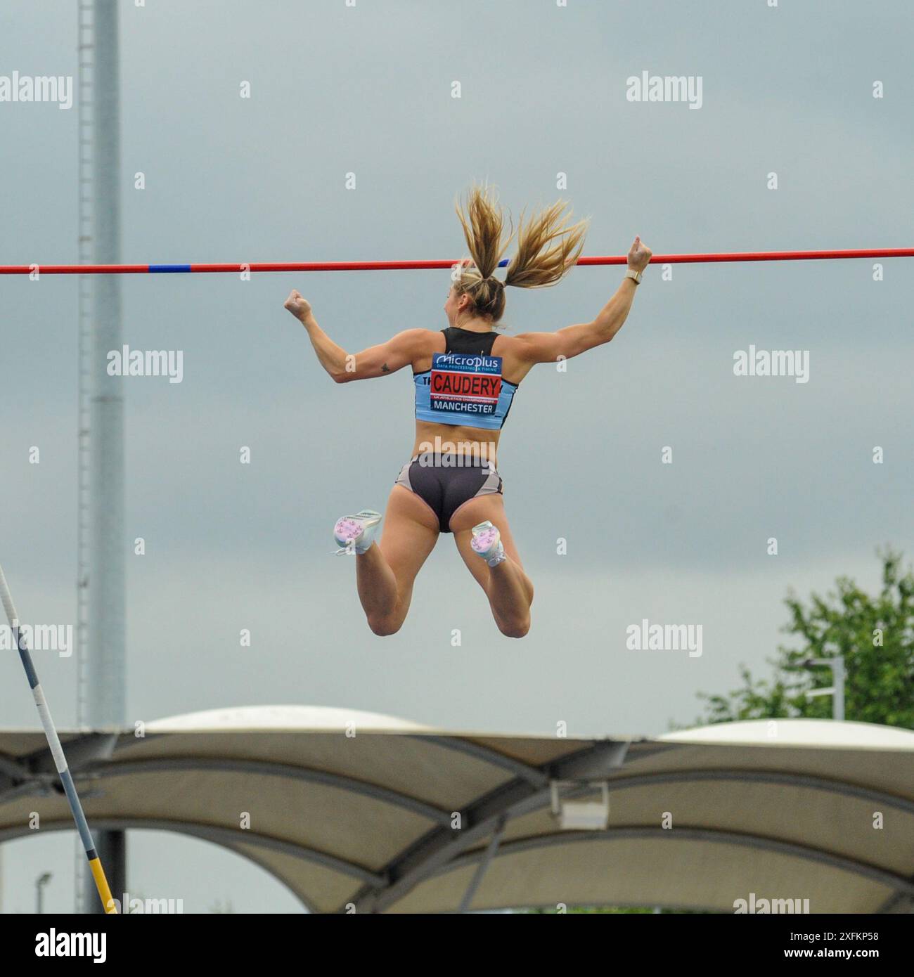 Molly Caudrey with her arms in the air as she goes over a height of 1 ...