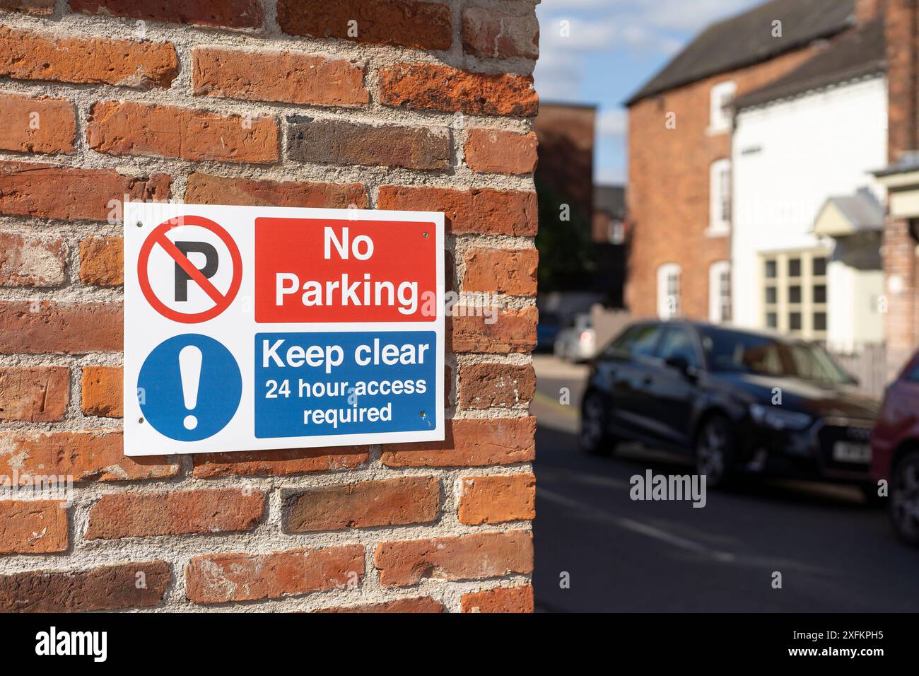 Close up of outdoor sign advising the public: 'No Parking, Keep Clear ...