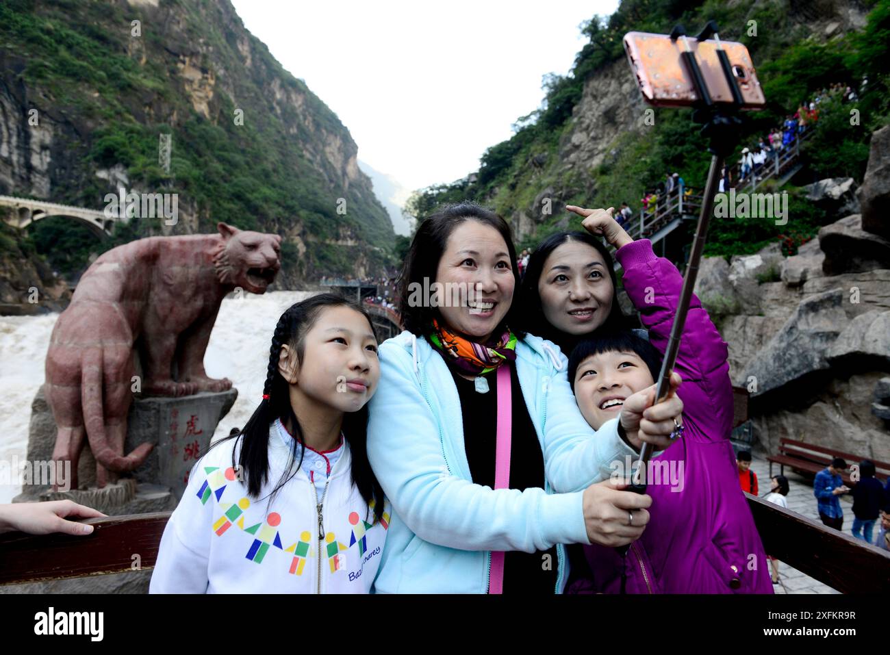 Chinese tourists taking selfie photos in front of statue in Tiger ...