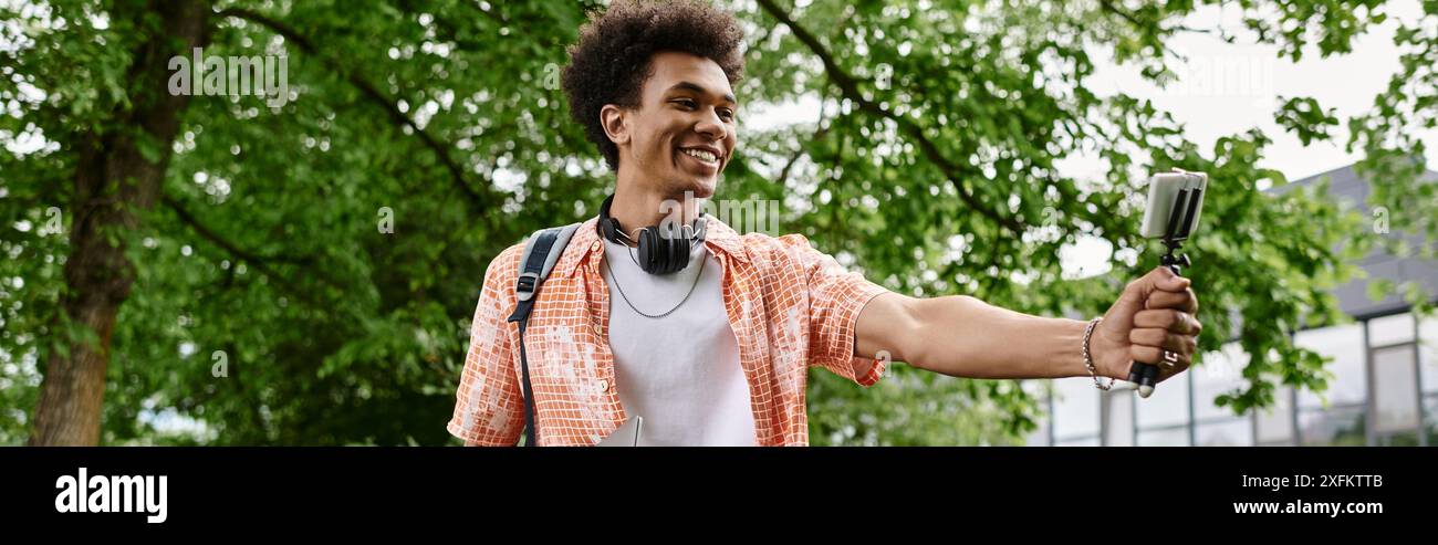 Young man, African American, holding a microphone in a park Stock Photo ...