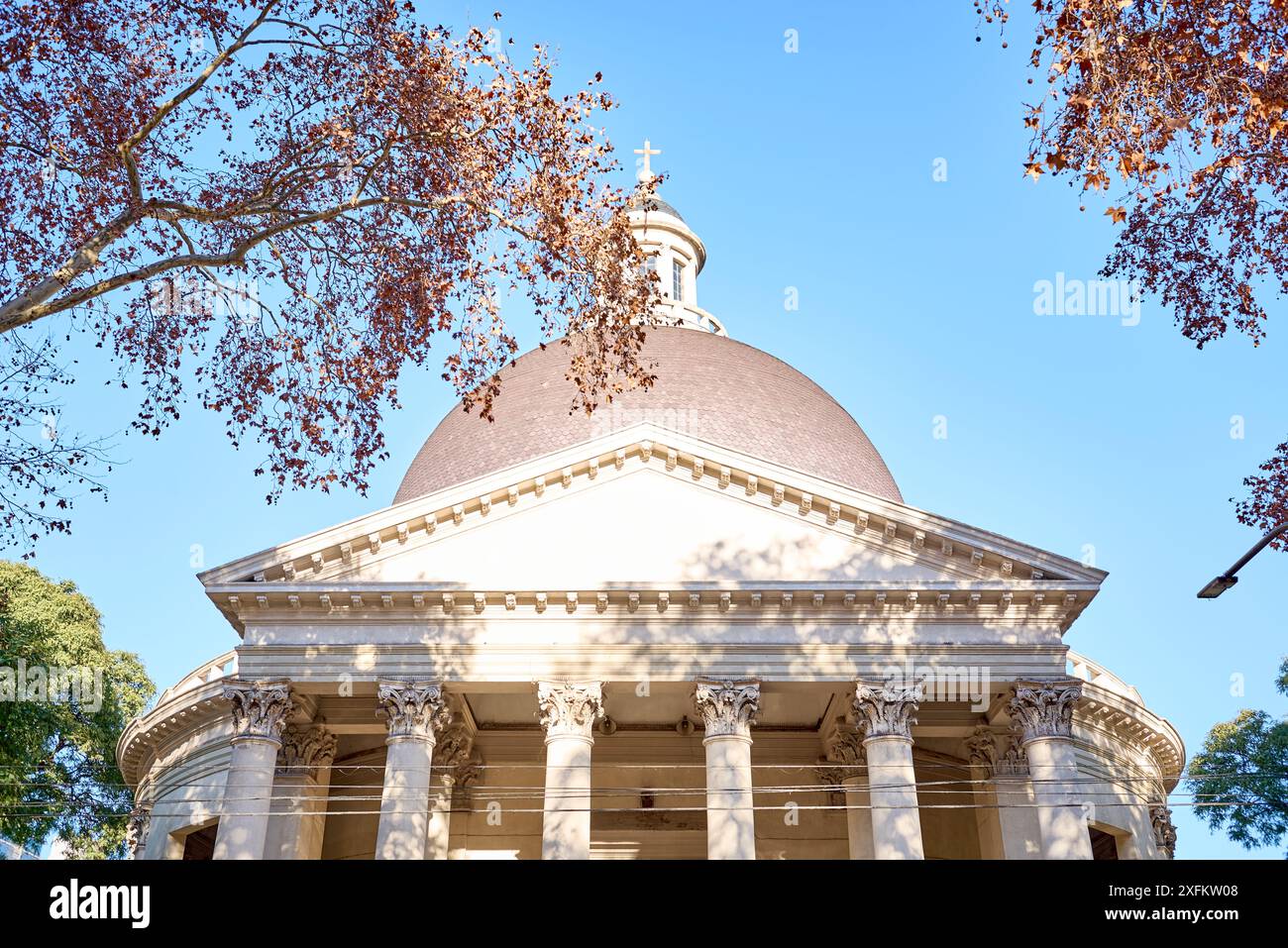 Close view of Christian church with cupola, bell tower and latin cross ...