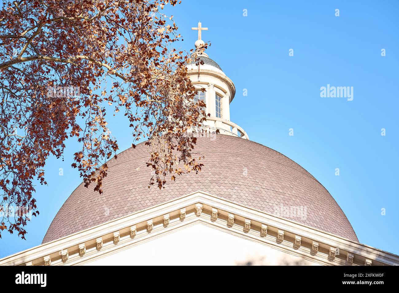 Tiled dome of a catholic church with rectangular windows at the top and ...