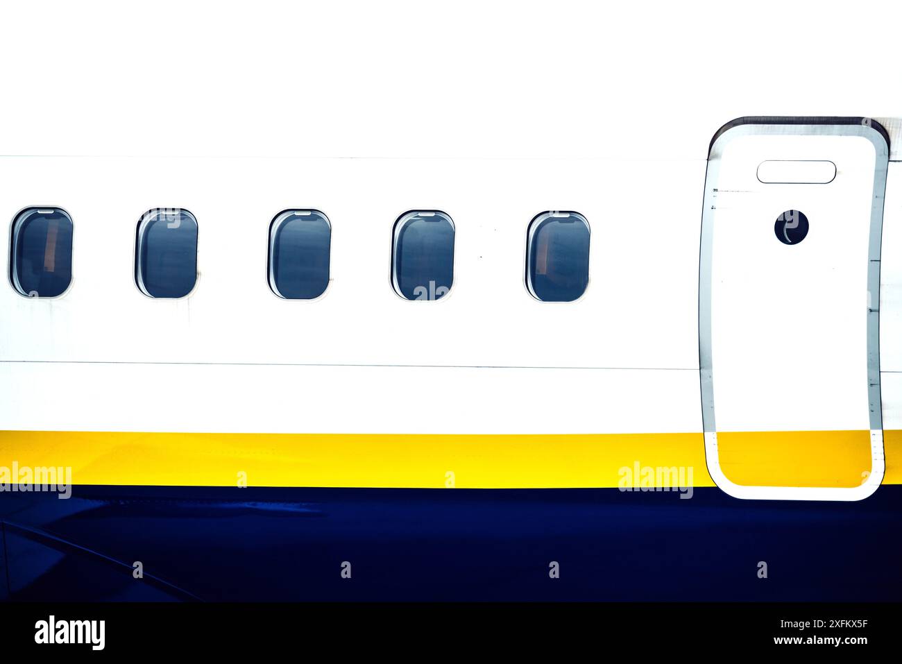 A close-up view of an airplane's exterior, featuring a row of five ...
