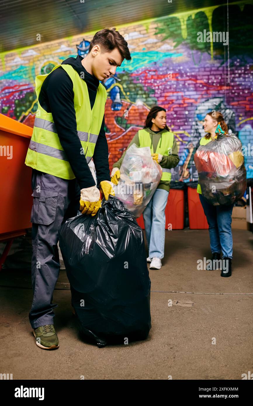 Young volunteers in safety vests and gloves sorting trash for a cleaner ...