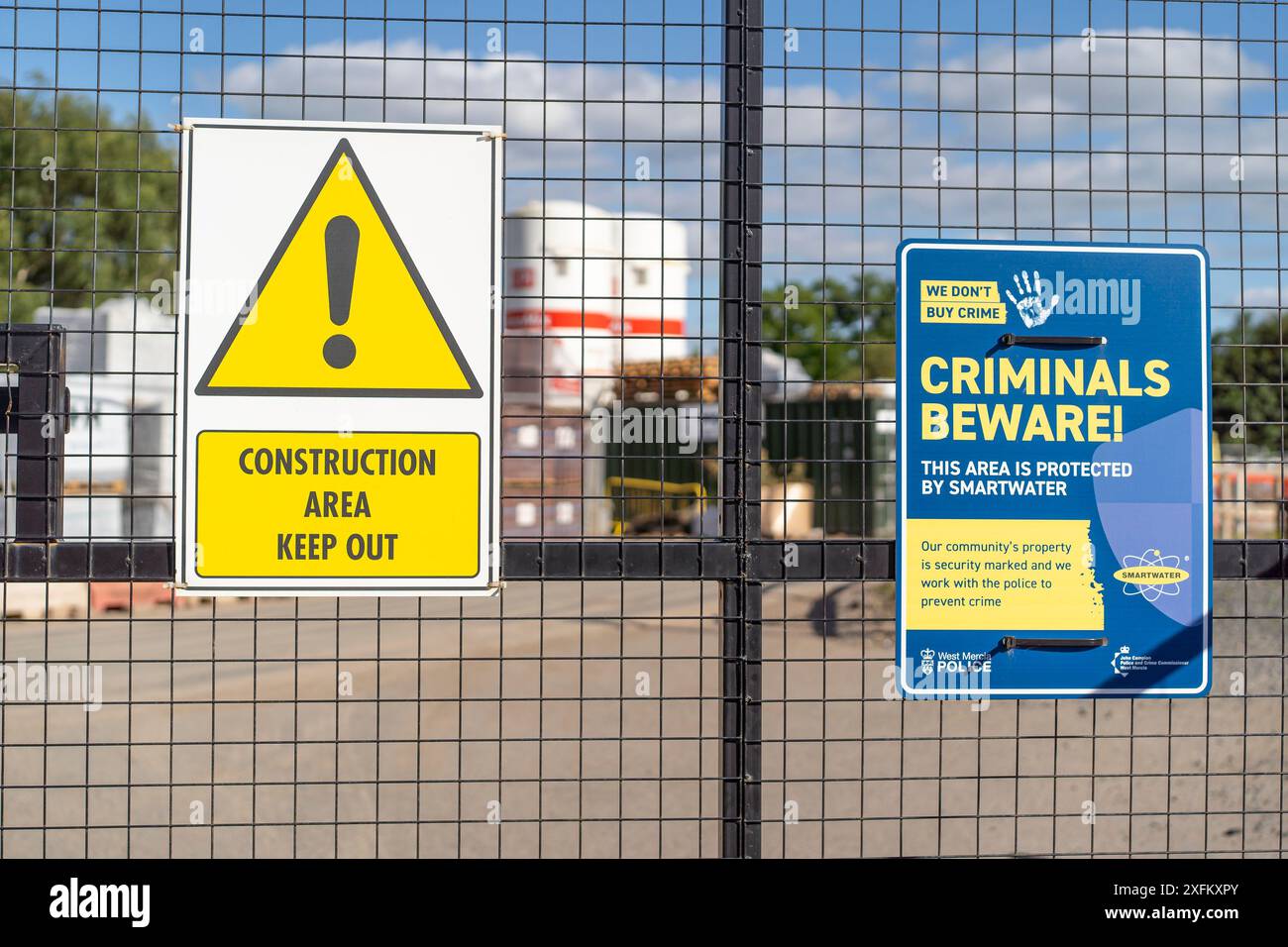 Construction Area Keep Out sign and Criminals Beware sign on wire ...