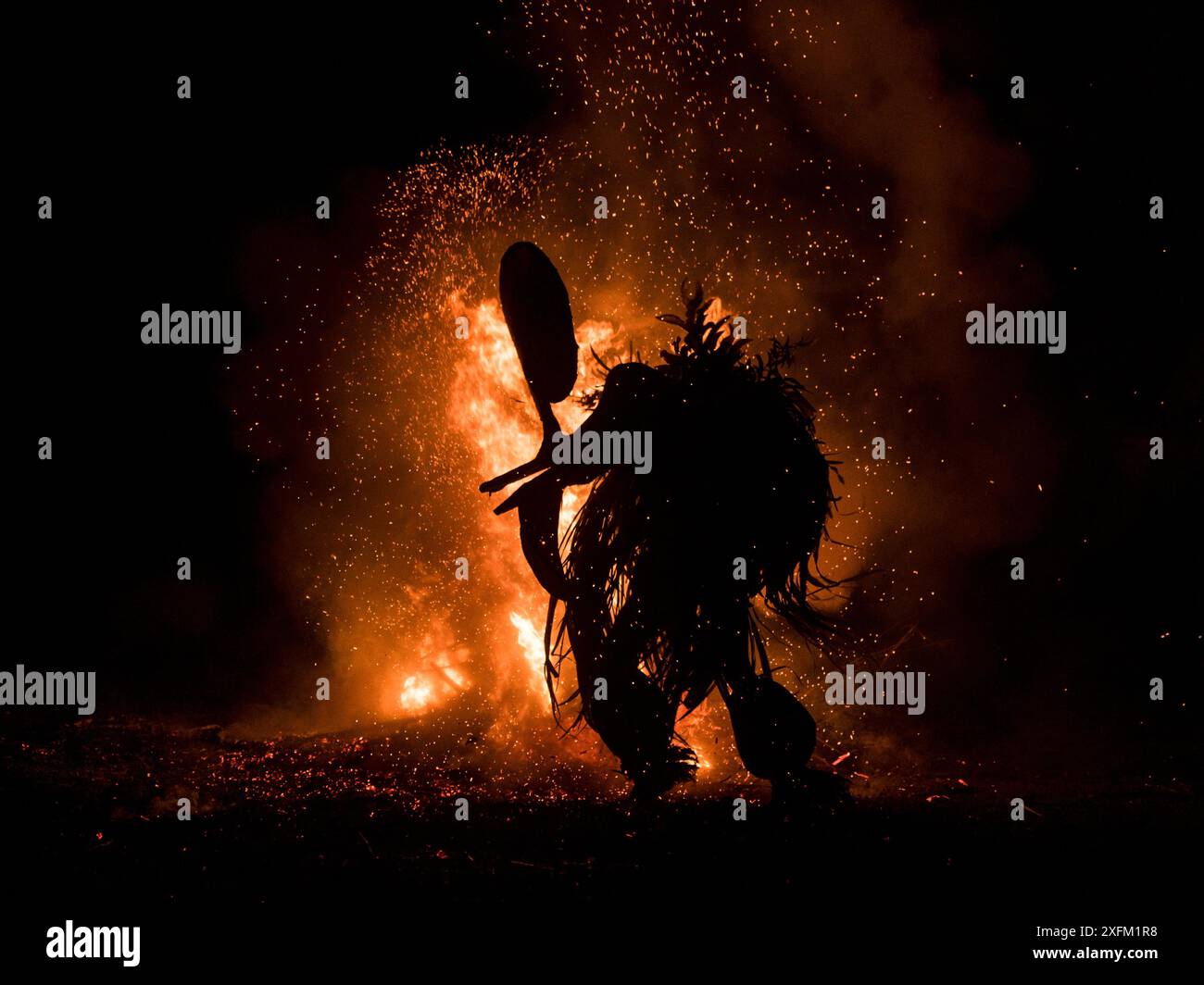 Baining men in traditional fire dance ceremony. Men enter a trance like ...