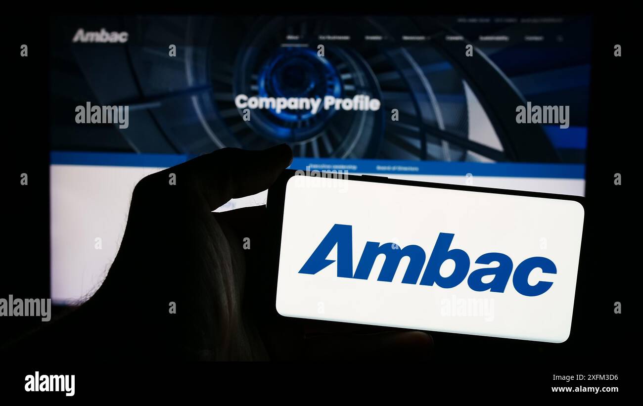 Person holding smartphone with logo of US finance company Ambac ...
