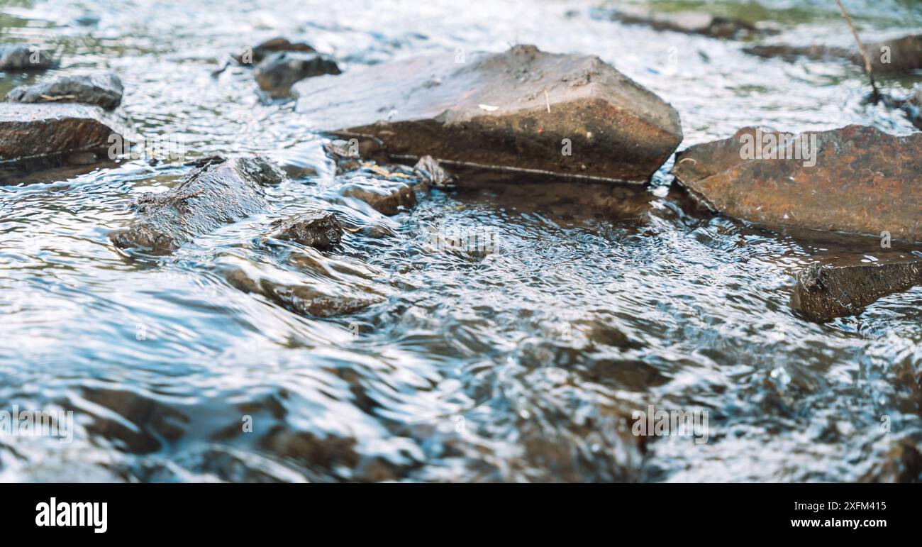 Spring stream flows over stones hi-res stock photography and images - Alamy