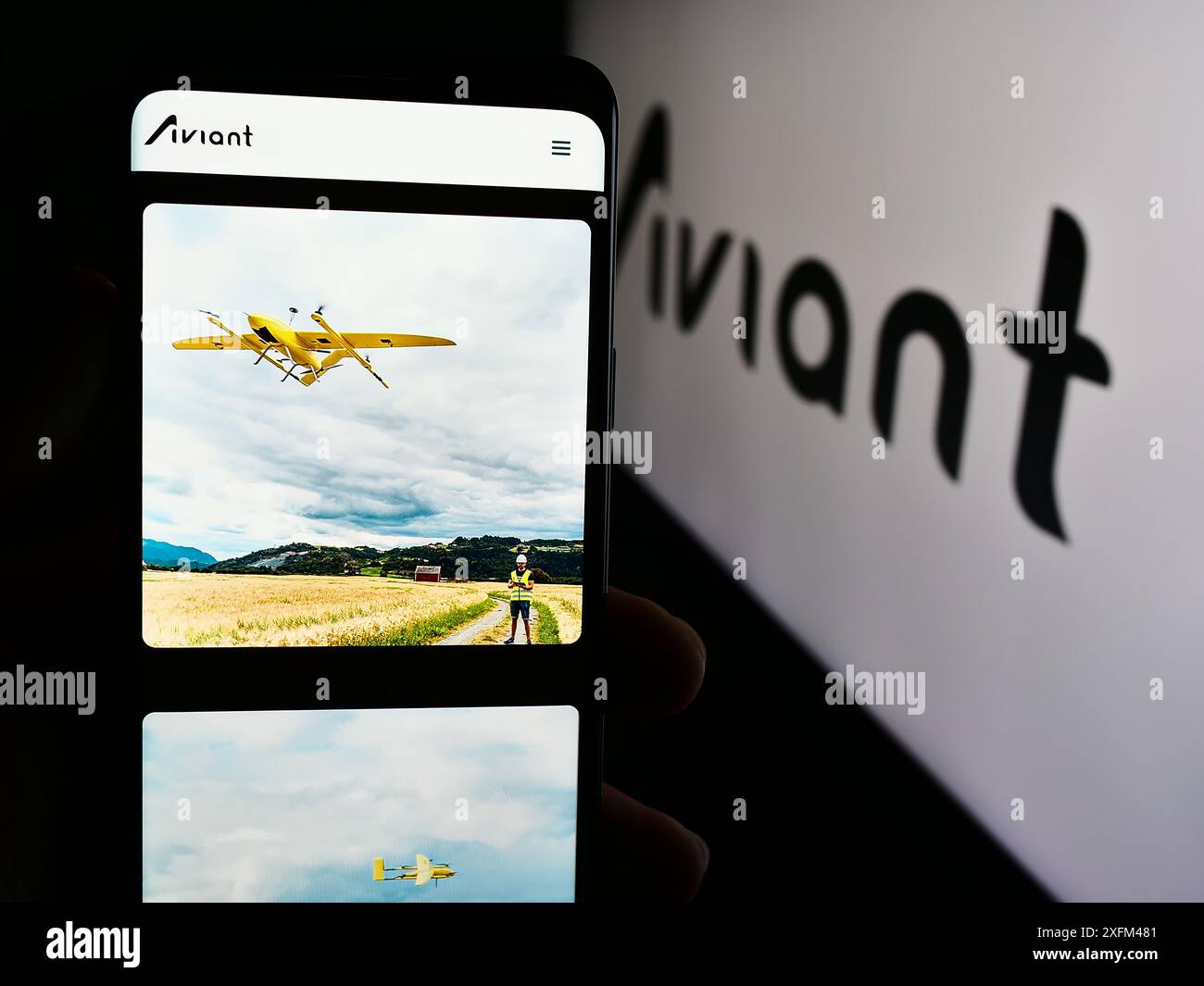 Person holding mobile phone with web page of Norwegian drone service ...