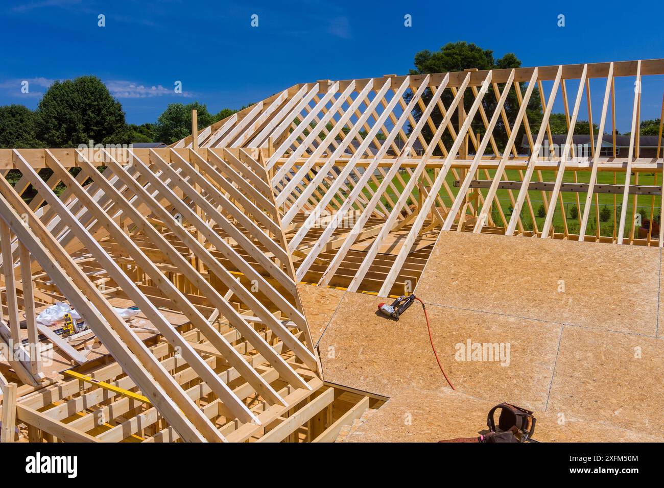 Timber roofing truss frame installation during construction of home ...