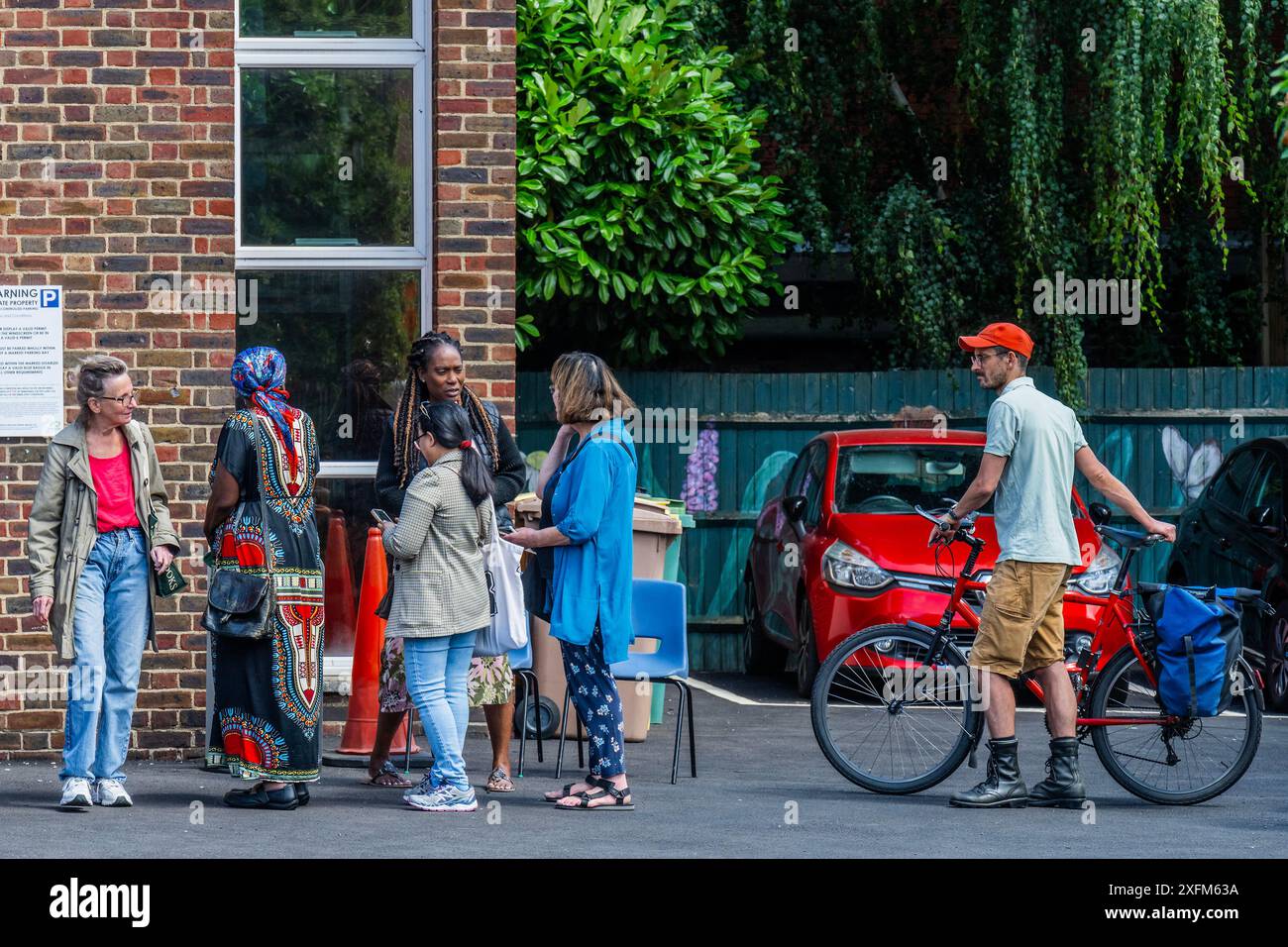 London, UK. 4th July, 2024. Large queues, including people of all ages ...