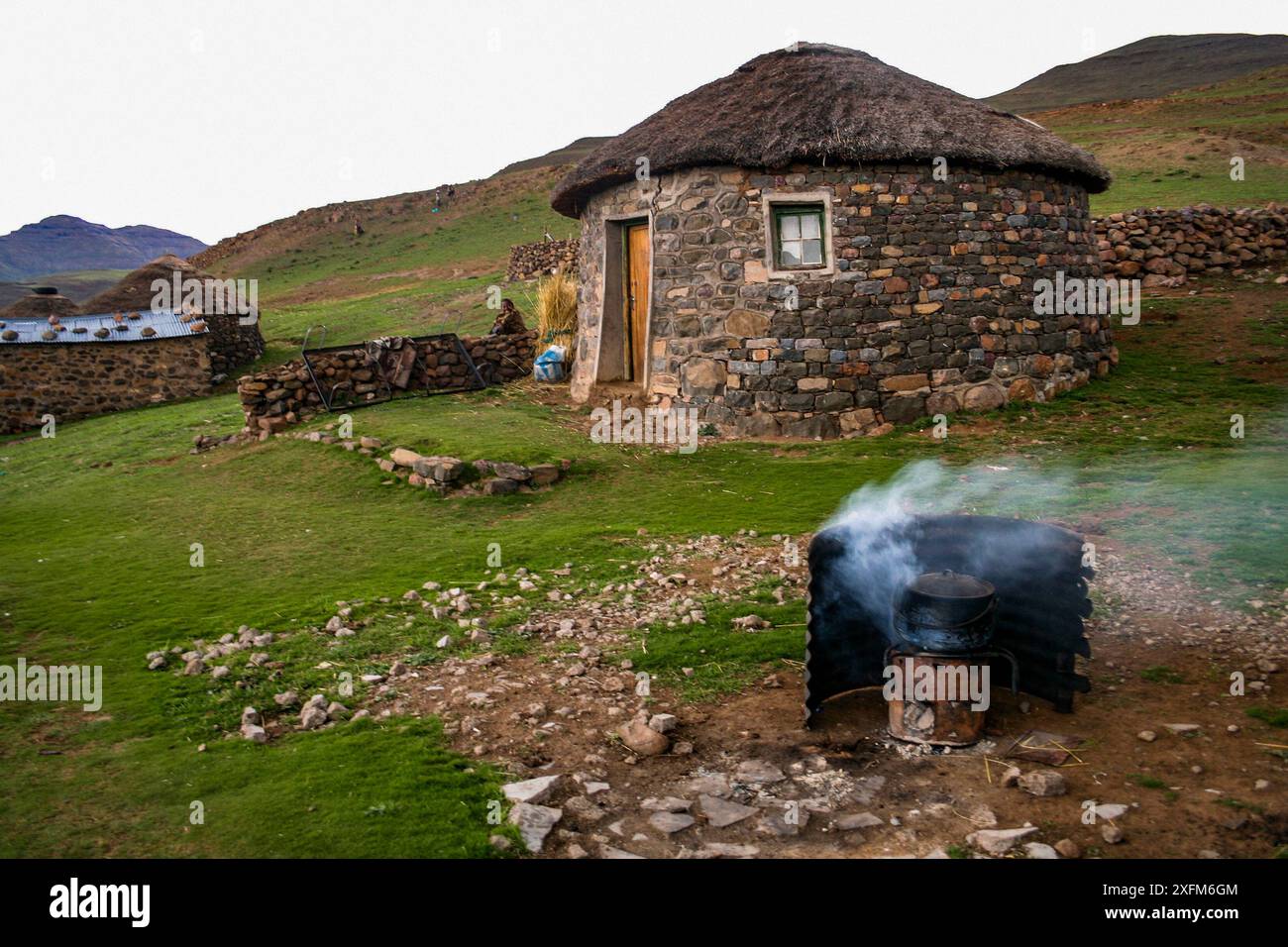 Traditional homestead with a stone hut and wood-fired stove. Lesotho ...