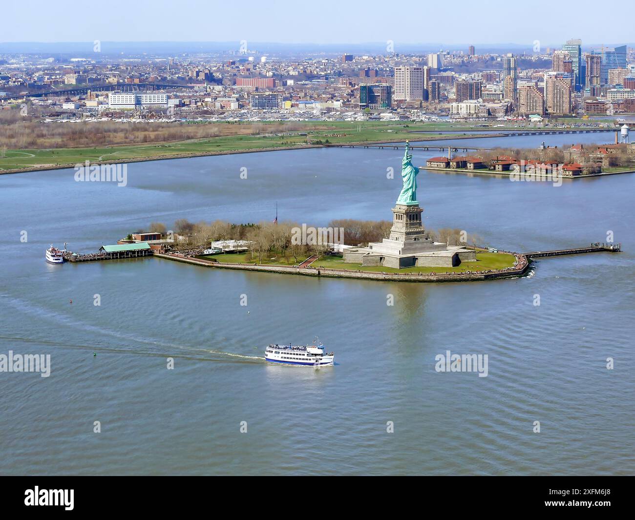 Aerial View of Liberty island and the statue of Liberty with New York ...