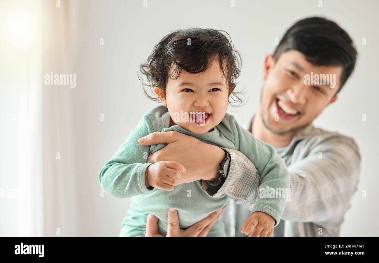 Asian dad, happy smile and baby for bonding together, support and ...