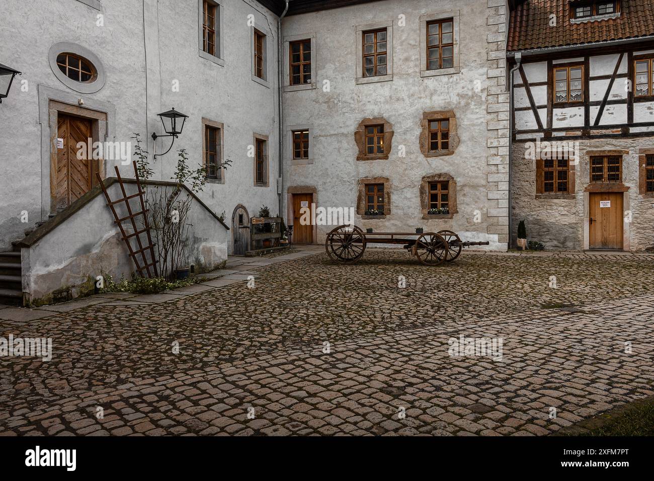 Courtyard of a farm with work materials for the harvest and sleeping ...