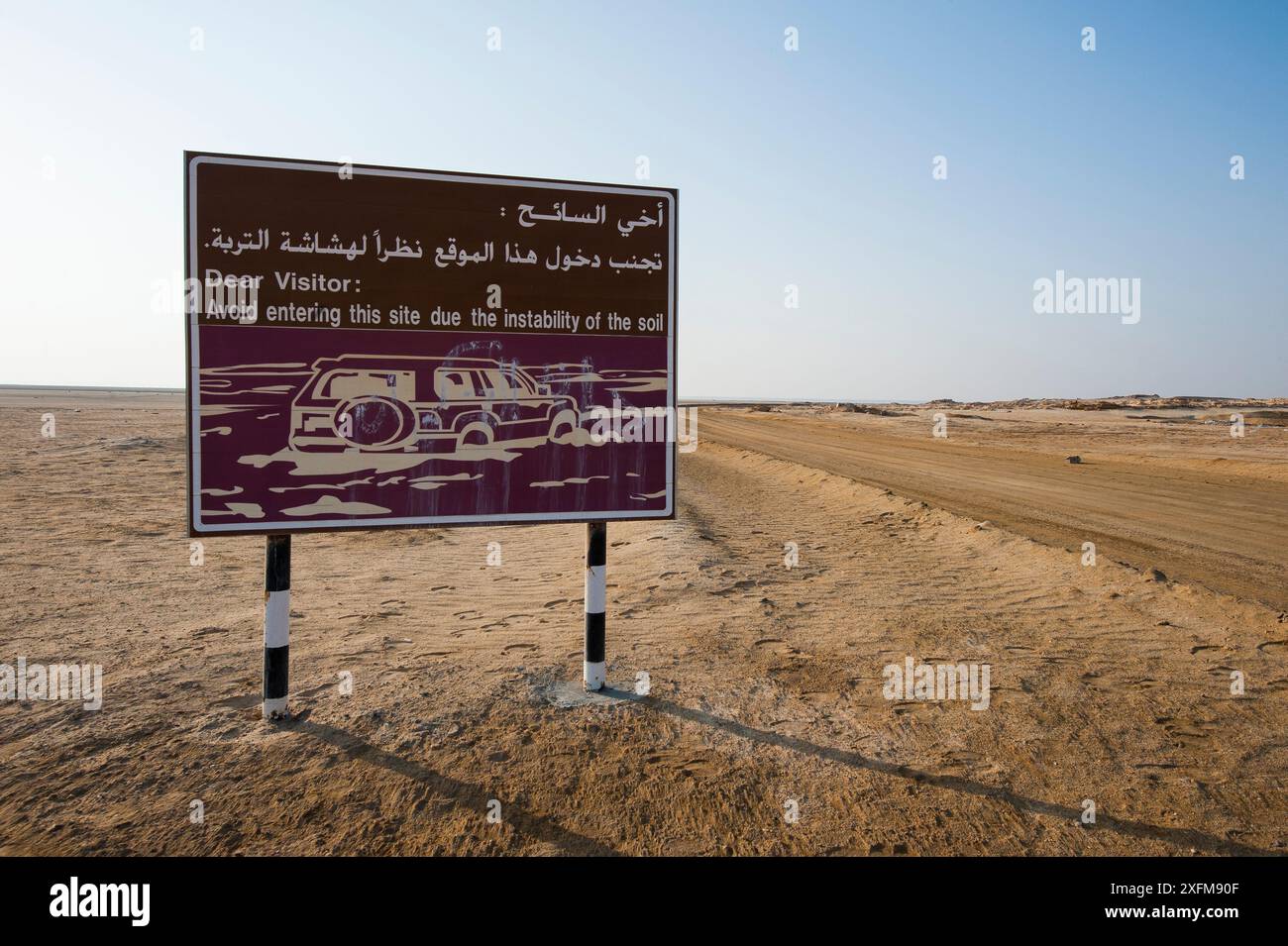 Sign warning about the danger of soft, mixed mud-salt-flats, locally ...