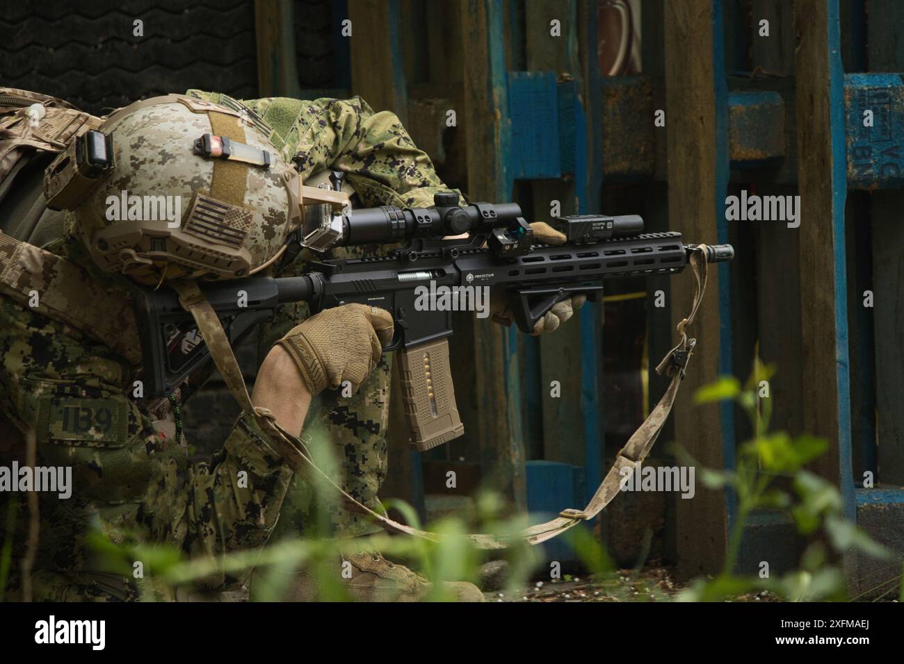 airsoft game on the street near abandoned buildings, a man in an ...
