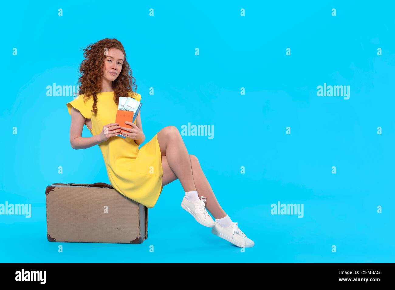 Traveler tourist woman in yewllow dress holding passport and tickets ...