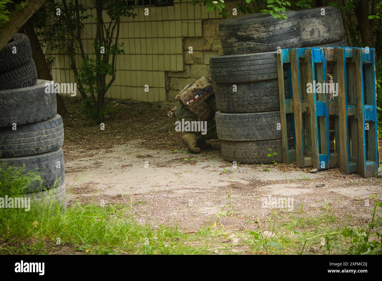 Airsoft game on the street near abandoned buildings, a man in an ...