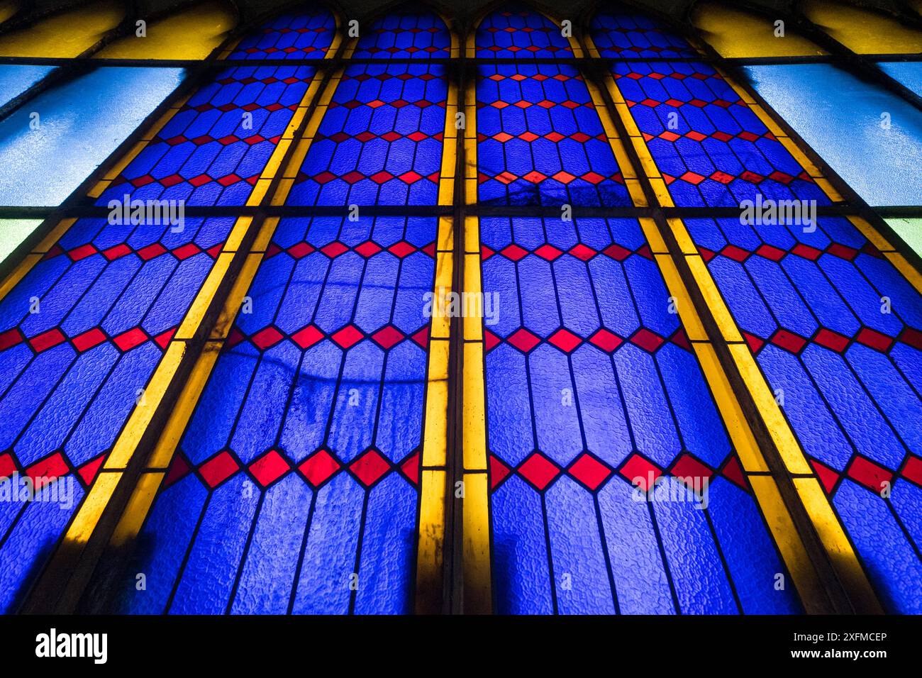 A stained glass window with blue and red squares Stock Photo - Alamy