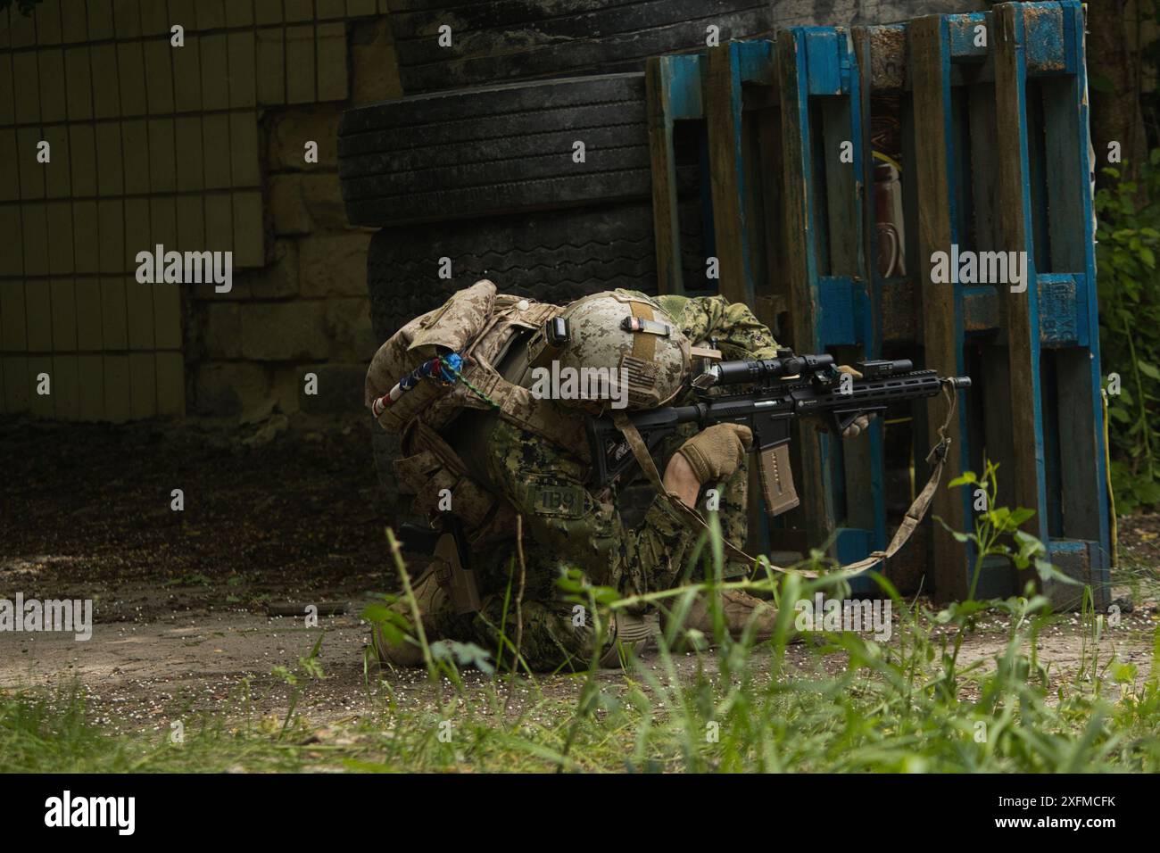 airsoft game on the street near abandoned buildings, a man in an ...