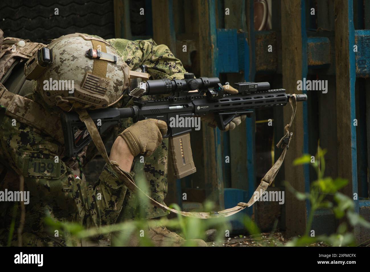 airsoft game on the street near abandoned buildings, a man in an ...