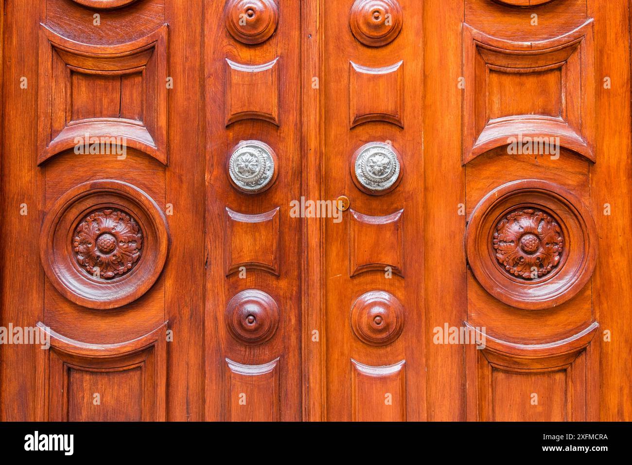The door is made of wood and has a fancy design on it. The door has two ...