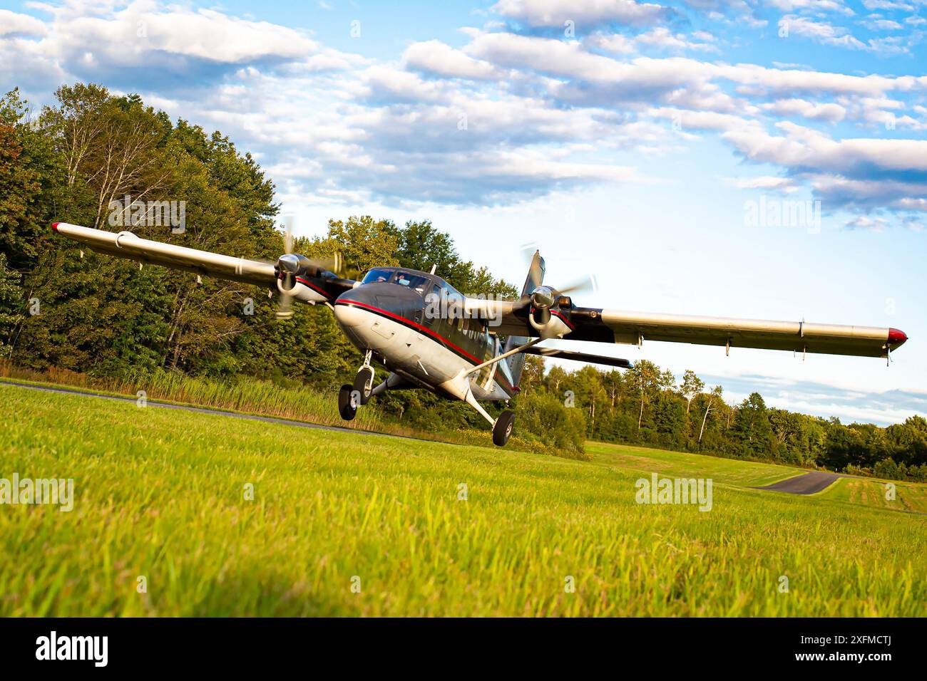 Small jet taking off at rural green runway field close up Stock Photo ...