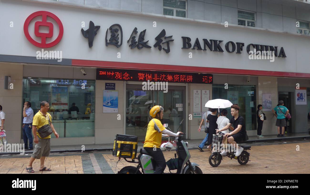 Delivery person rides past the Chinese majority-owned commercial bank ...