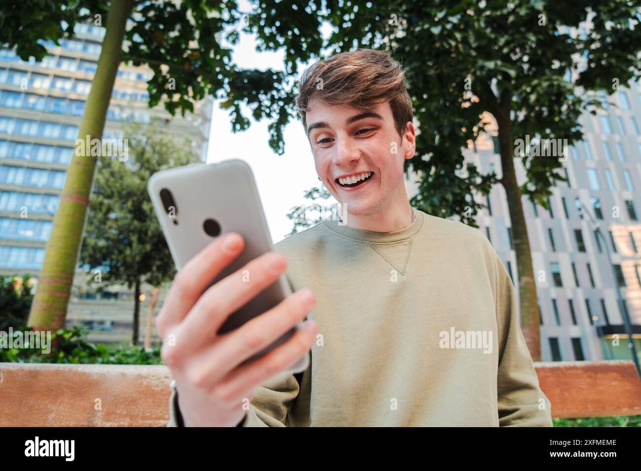 Browsing on smartphone standing outside hi-res stock photography and ...