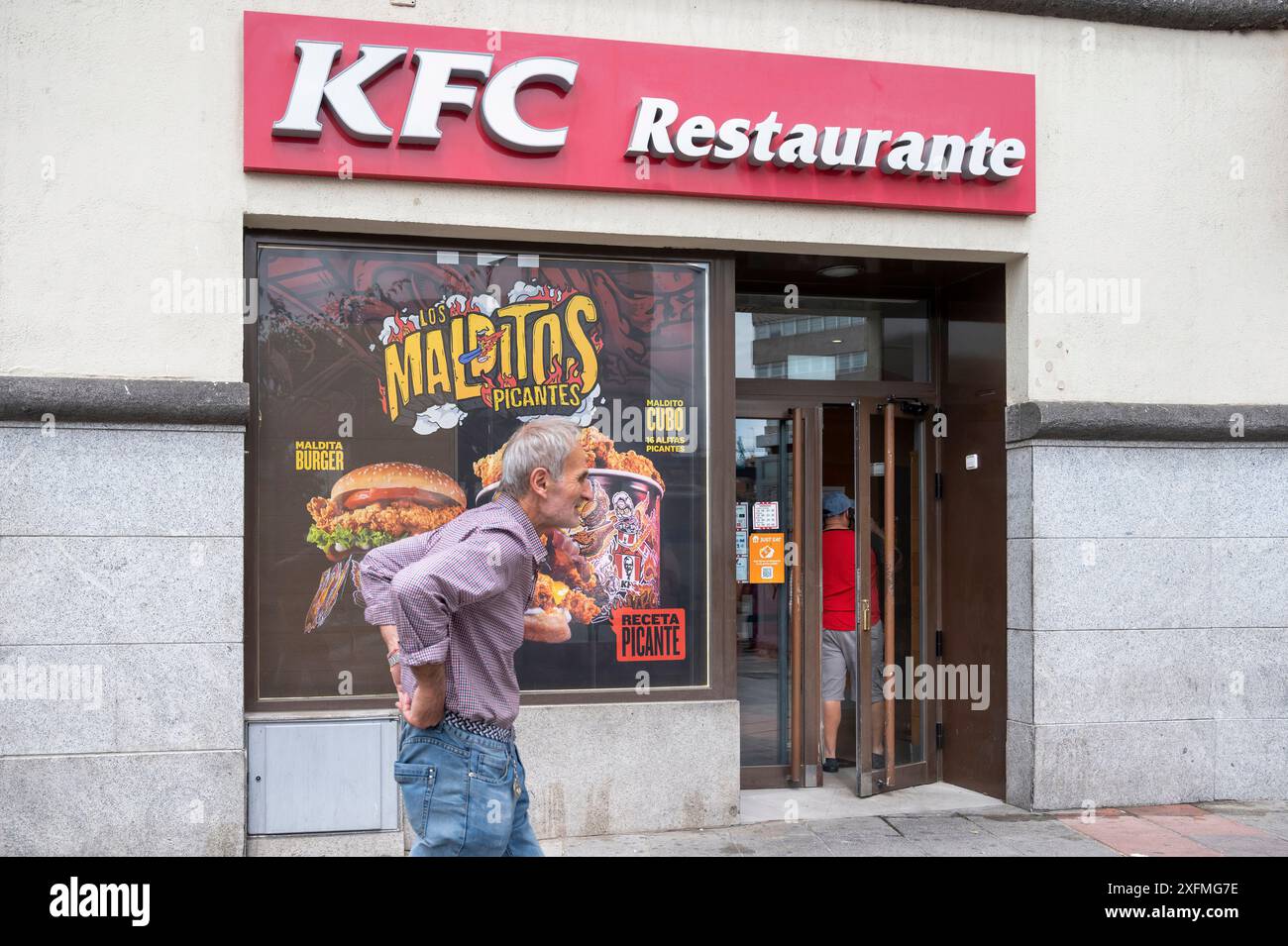 A pedestrian walks past the American fast food chicken restaurant chain ...