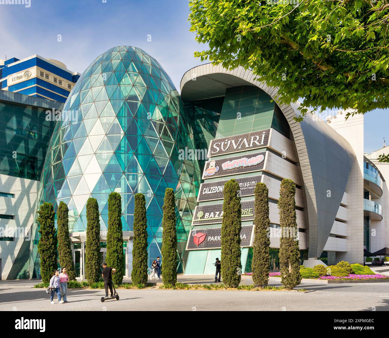 Baku, Azerbaijan - May 10 2024: Few people walk near the modern design ...