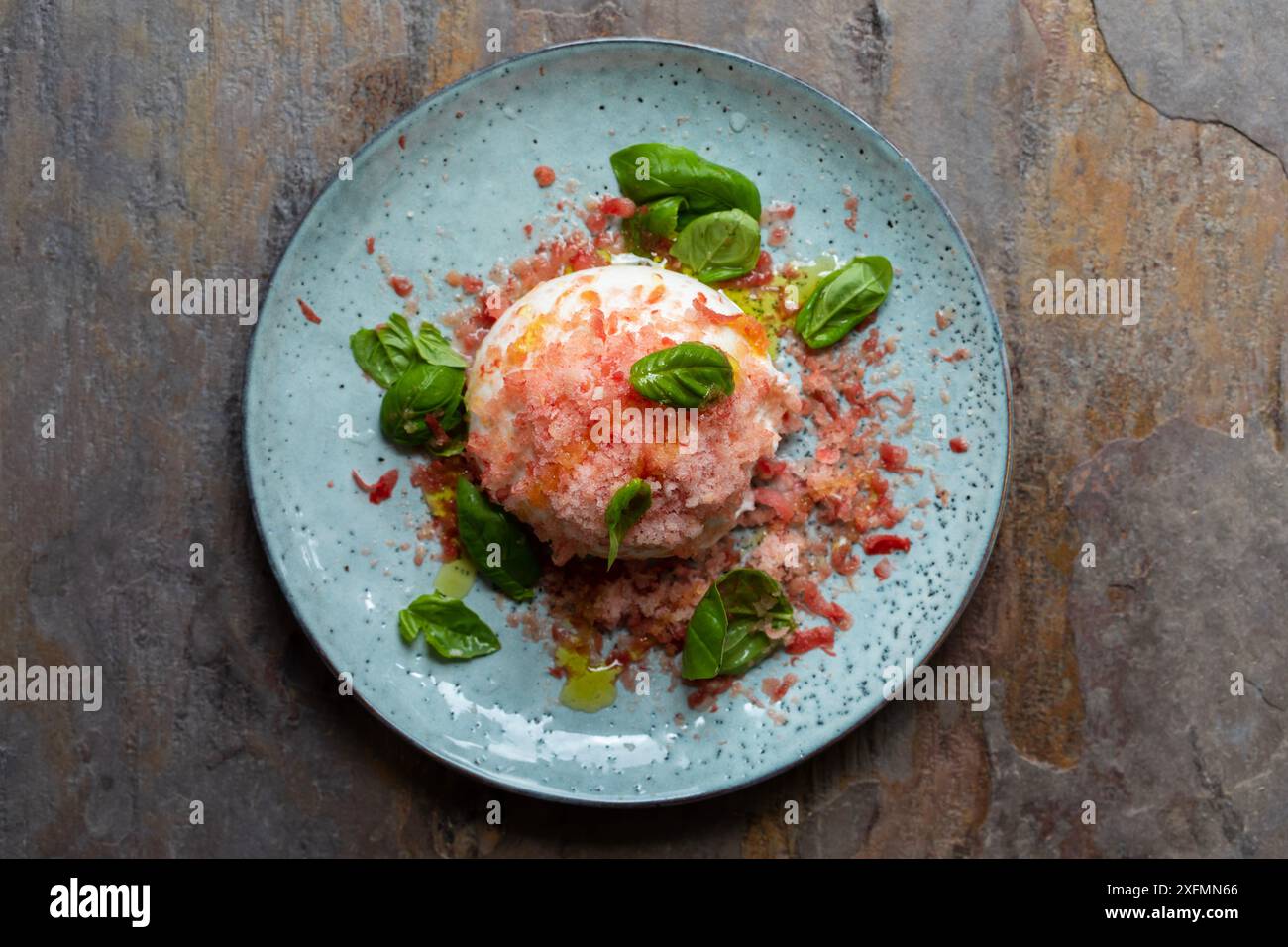 Burrata cheese with frozen tomato, basil and olive oil Stock Photo - Alamy