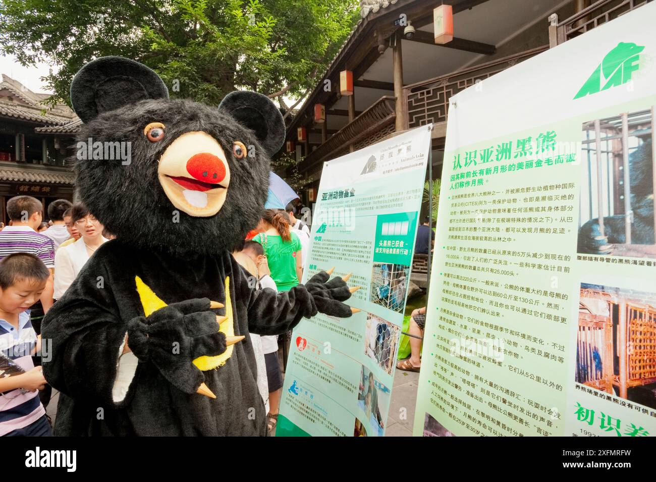 Person in a Moon bear costume showing display boards about bear bile ...