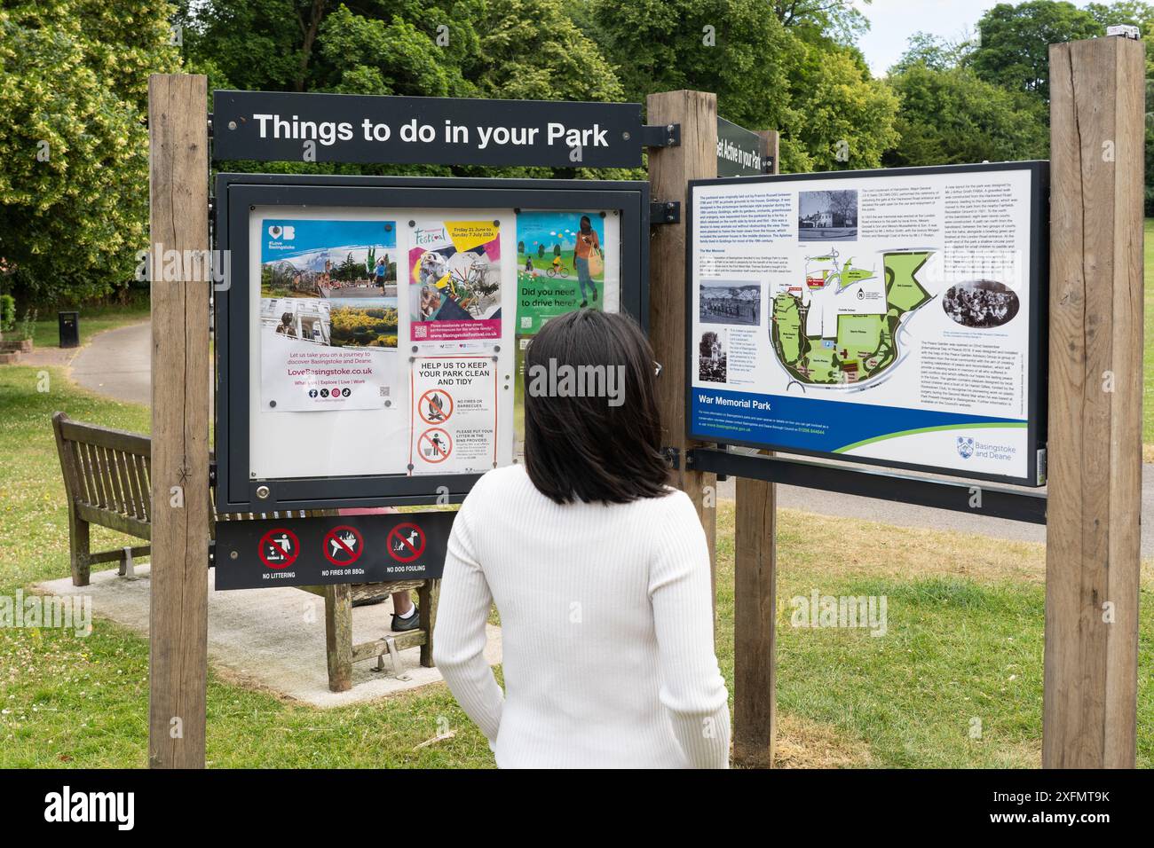 A woman viewing an information board of 'Things to do in your Park' at ...