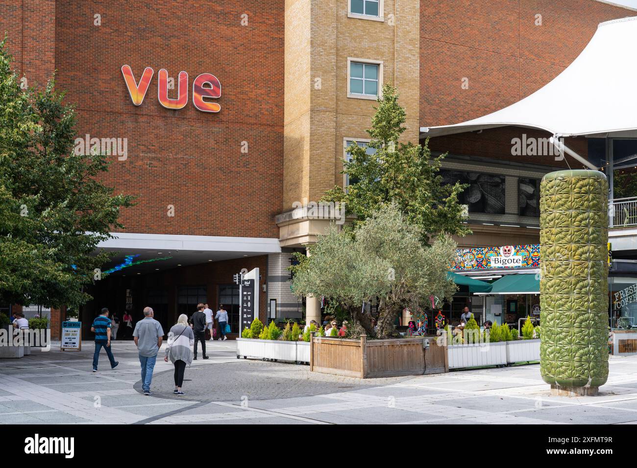 People walking and dining in Festival Square outside Festival Place shopping centre on a summer ...