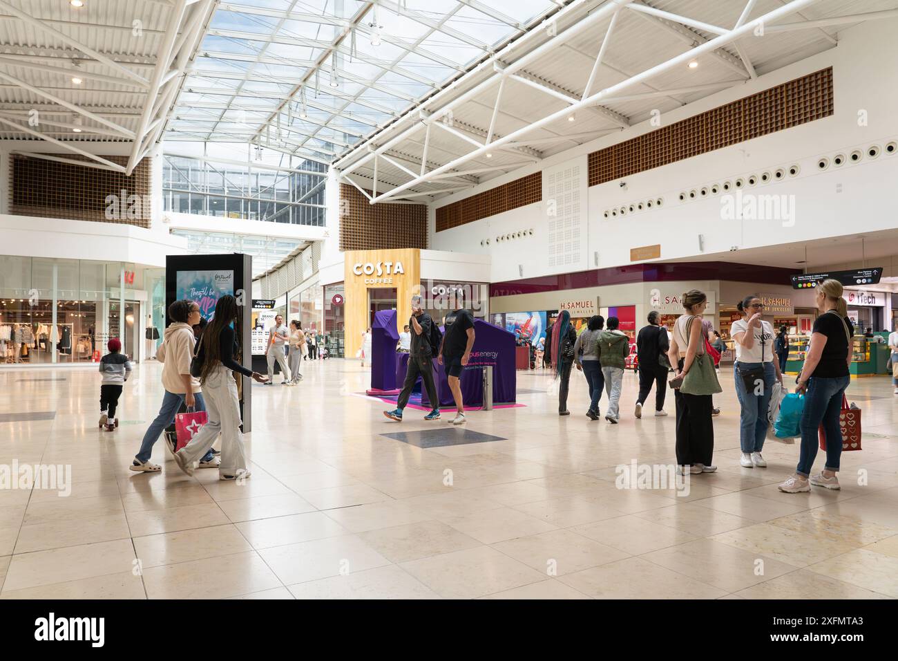 Shoppers walking through Festival Place, a covered shopping centre in ...