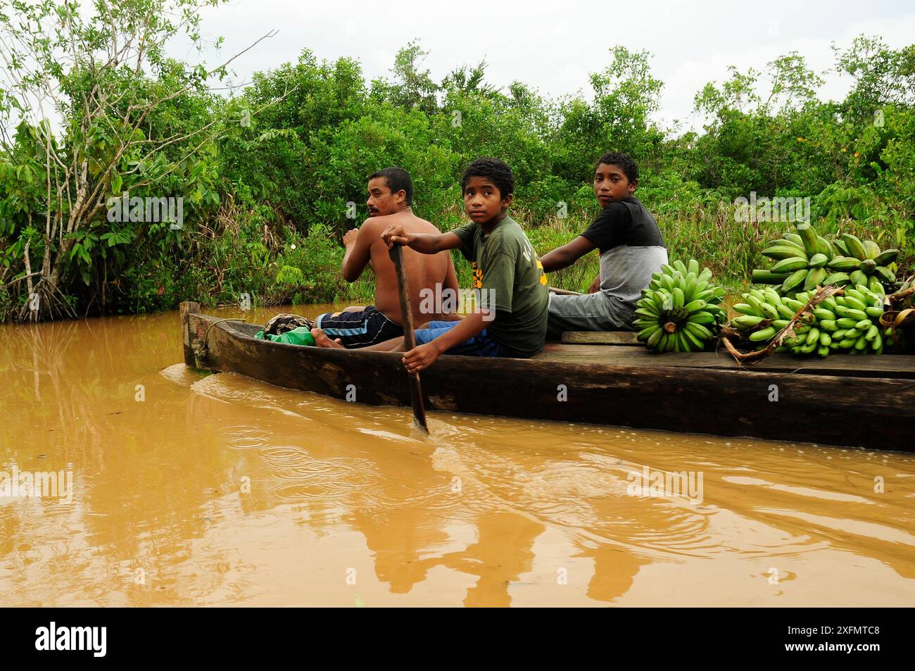 Family travelling in canoe on the Rio Platano, Rio Platano Biosphere ...