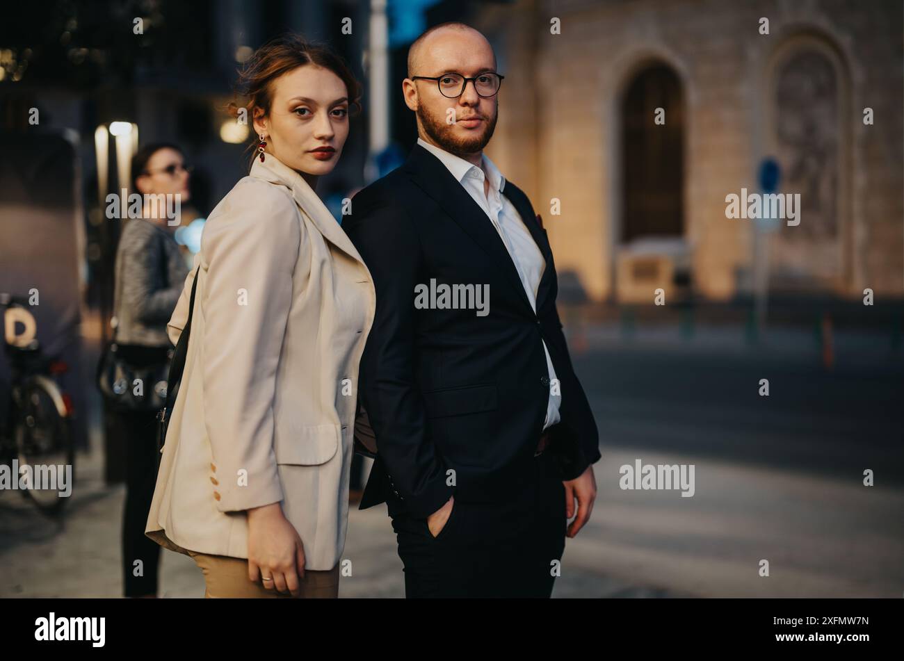Elegant young couple in formal attire on a city street at night Stock ...