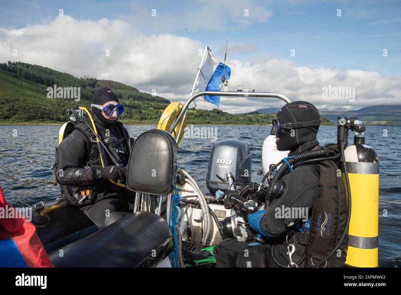Two divers undertaking their final checks on dive boat, Lamlash Bay ...