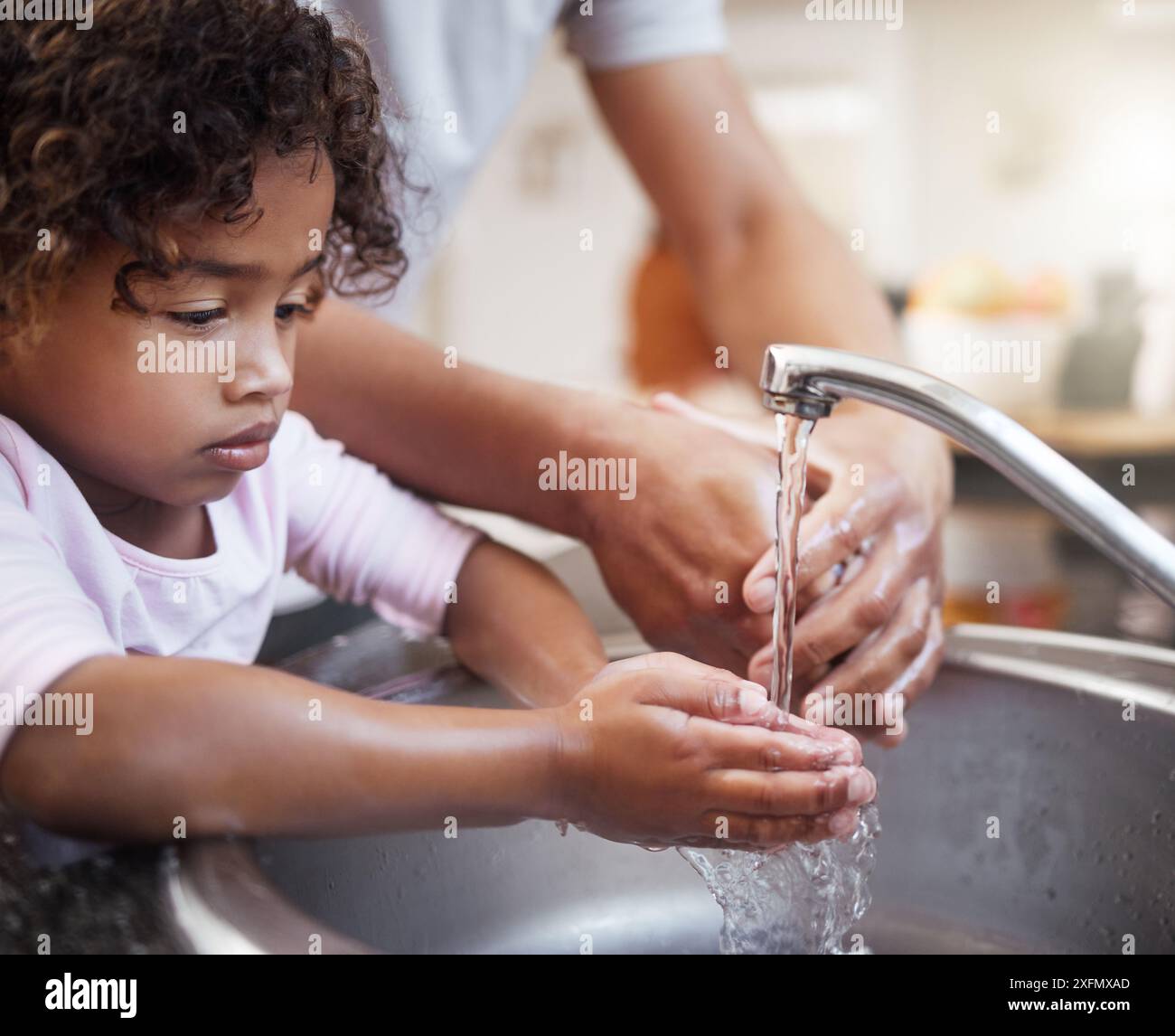 Child, washing hands and learning hygiene with parent for healthcare, development and bacteria ...