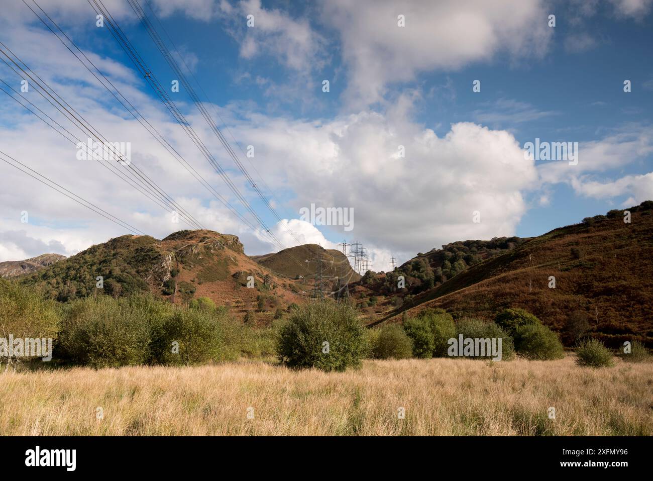 Power lines and pylons carrying electricity over mountain landscape ...