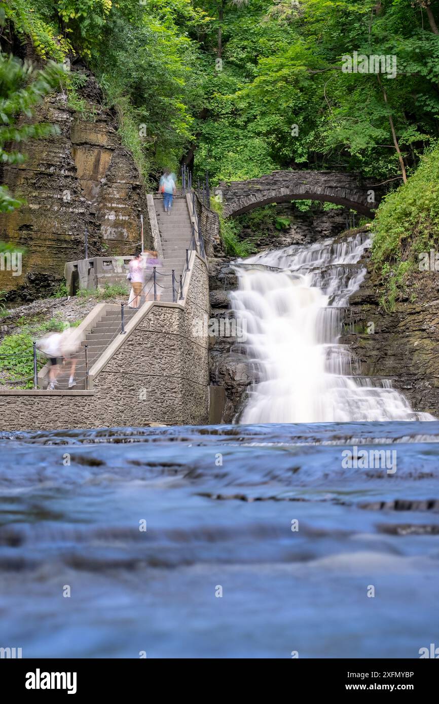 Vertical photo of a waterfall with a trail / concrete stairs ...