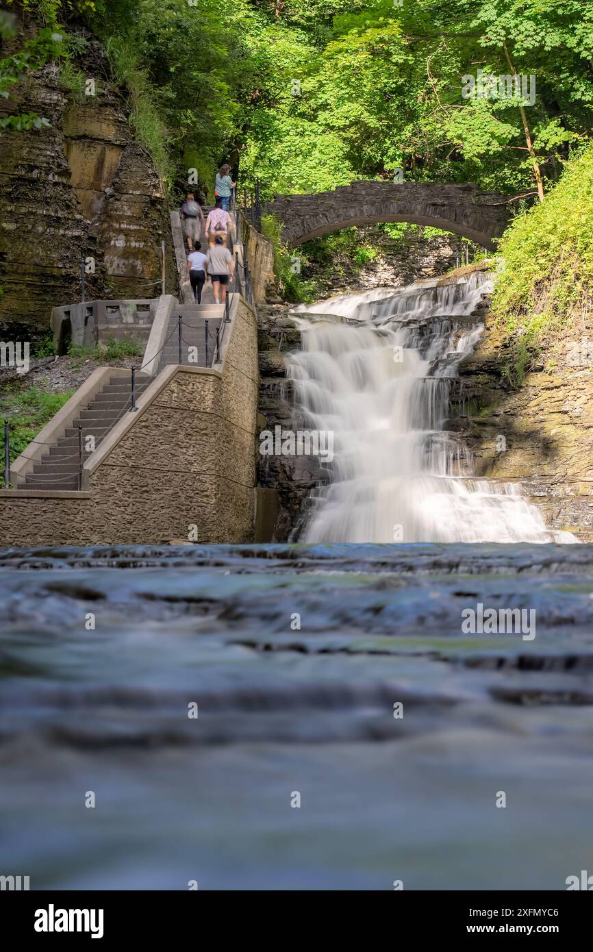 Vertical photo of a waterfall with a trail / concrete stairs ...